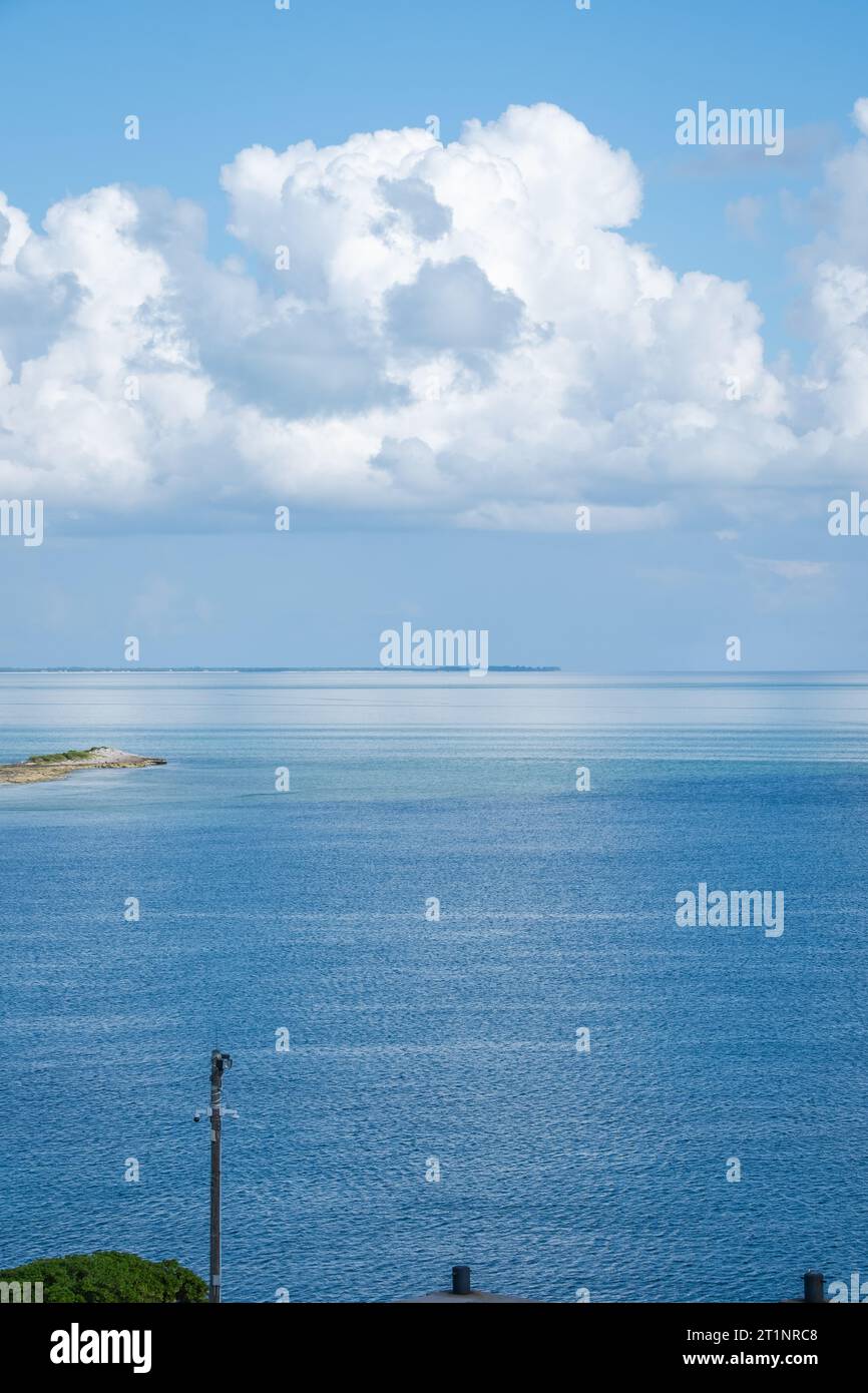 Blue sky with white fluffy clouds reflection on the water in the ...