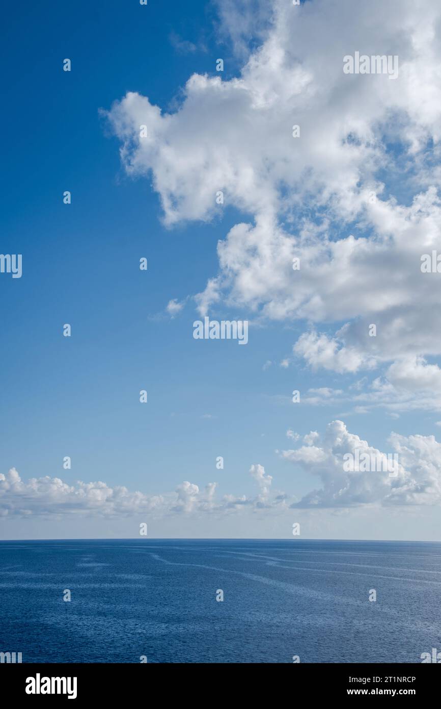 Blue sky with white fluffy clouds reflection on the water in the ...