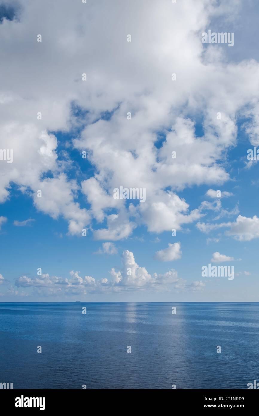 Blue sky with white fluffy clouds reflection on the water in the ...