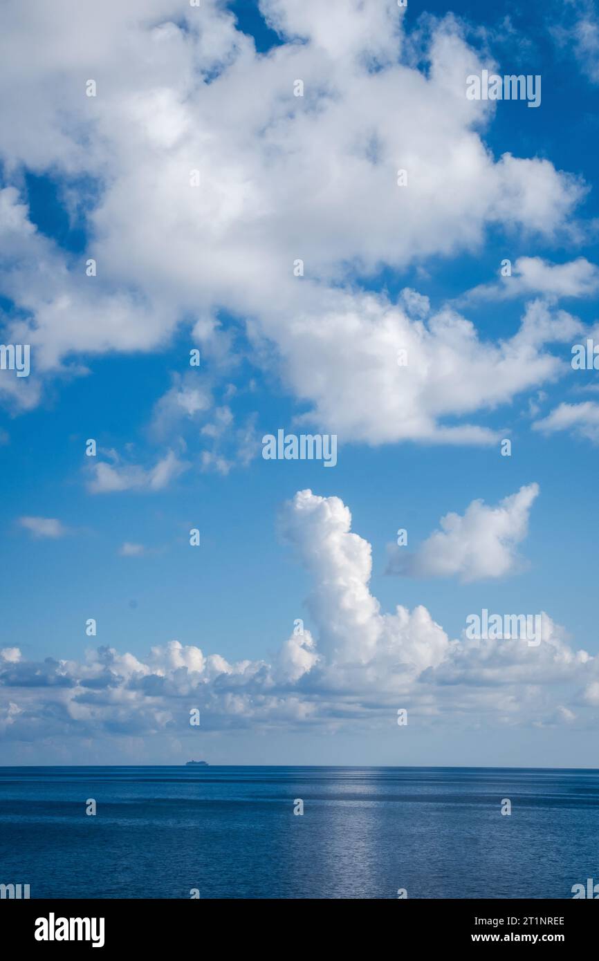Blue sky with white fluffy clouds reflection on the water in the ...
