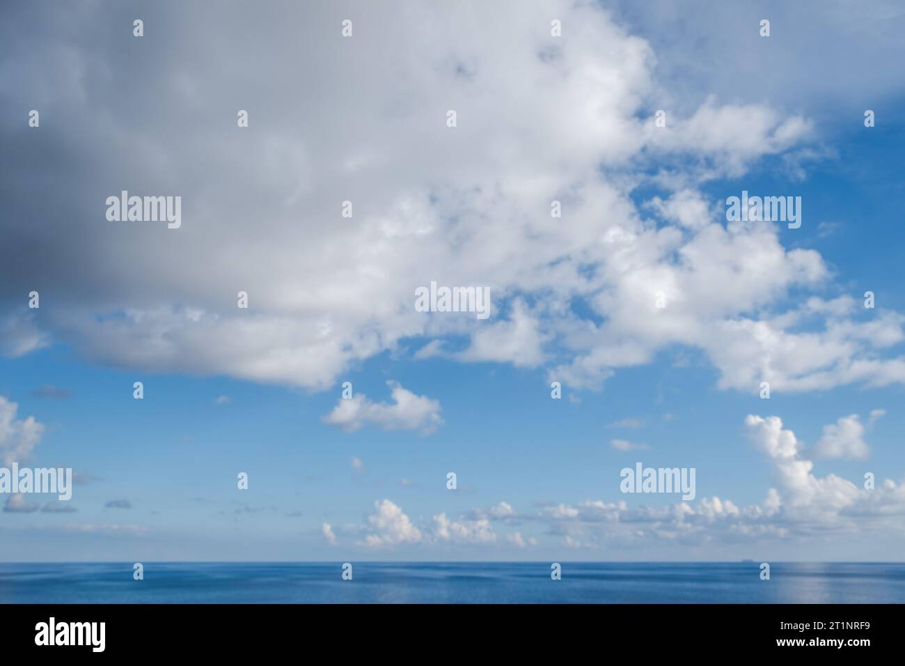Blue sky with white fluffy clouds reflection on the water in the ...