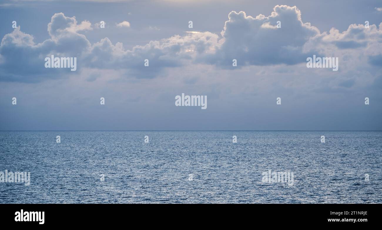 Blue sky with white fluffy clouds reflection on the water in the ...