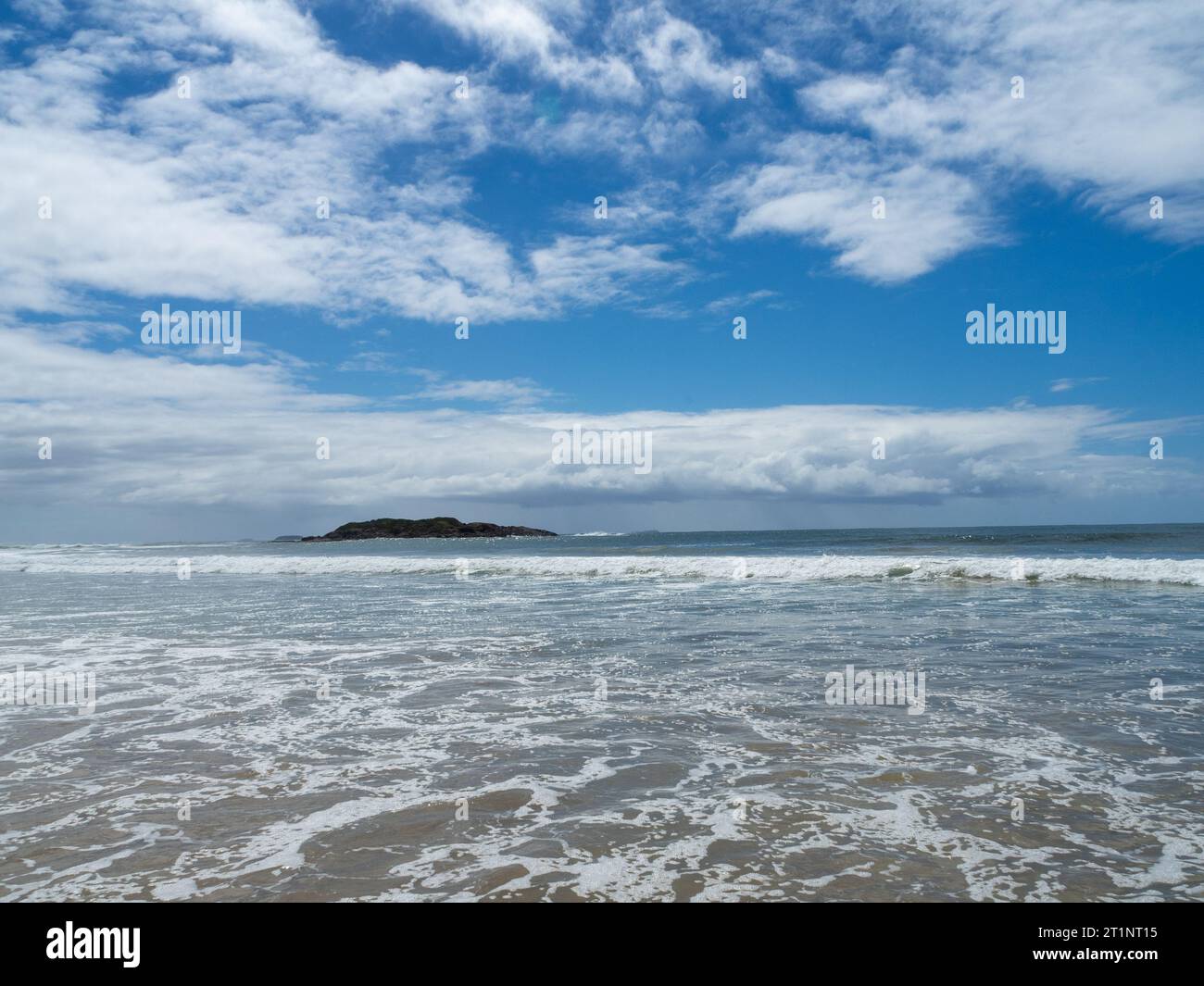 Blue and White Sea water below and blue sky with white clouds above the ...