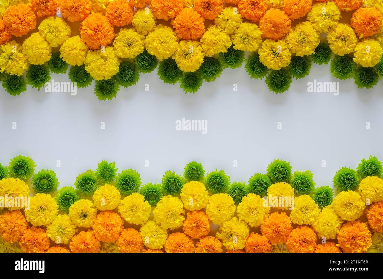 Decorative rangoli made from colorful marigold flowers and green ...