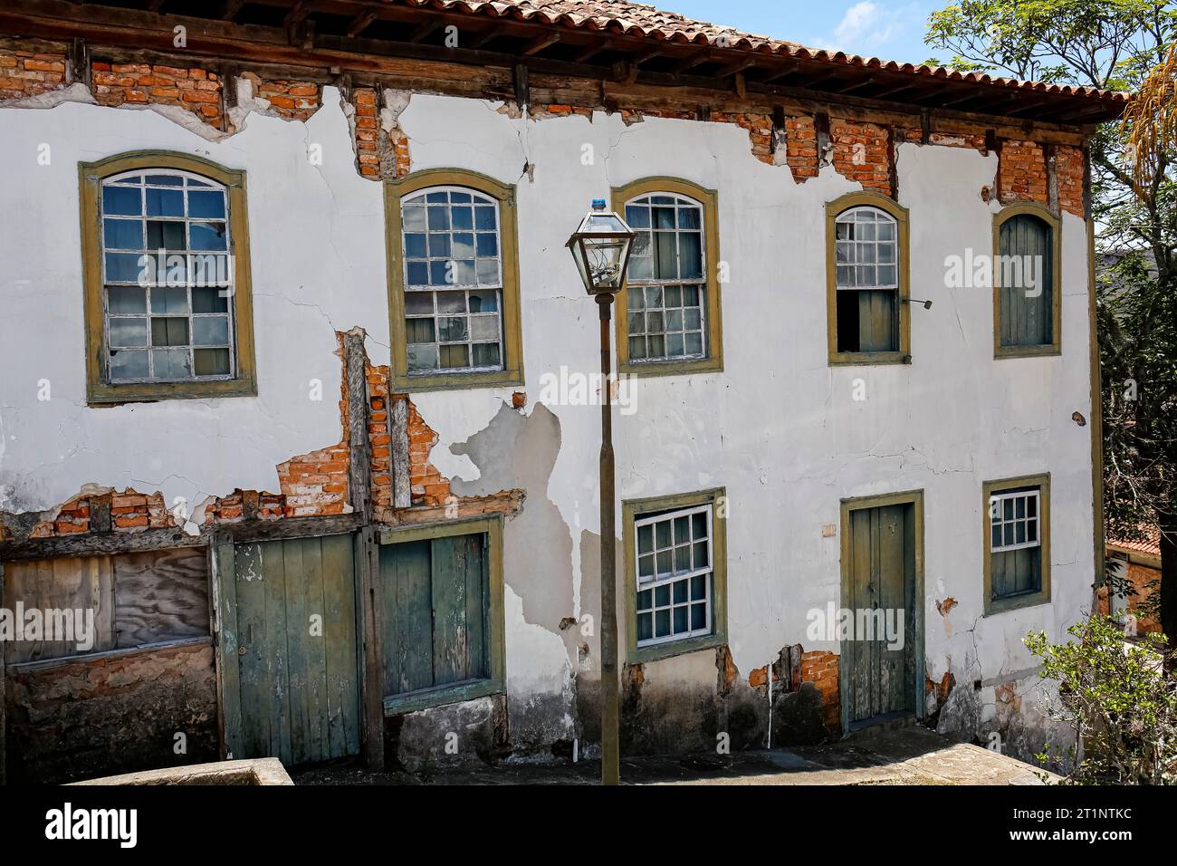 Run-down historic building with visible red bricks, Serro, Minas Gerais ...