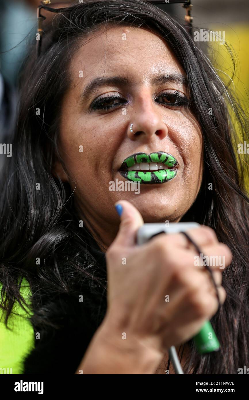 London, UK. 14th Oct, 2023. A protester with 'Love' written on both ...