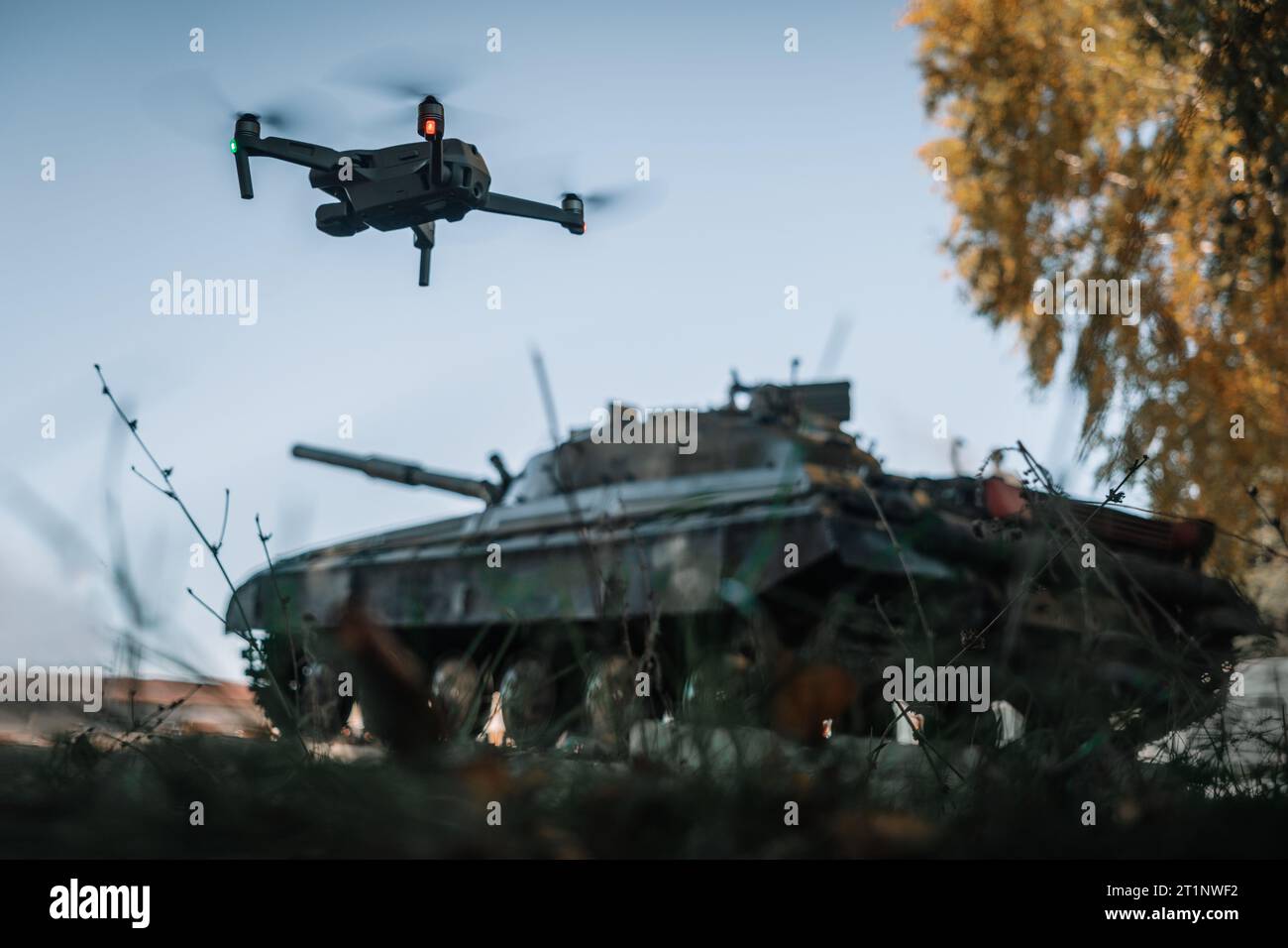 a drone flying above the tank in the background in nature. help of ...