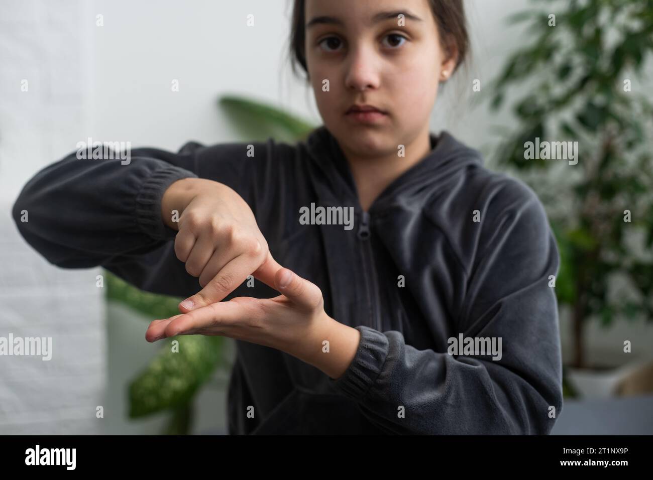 Beautiful smiling deaf girl using sign language Stock Photo - Alamy