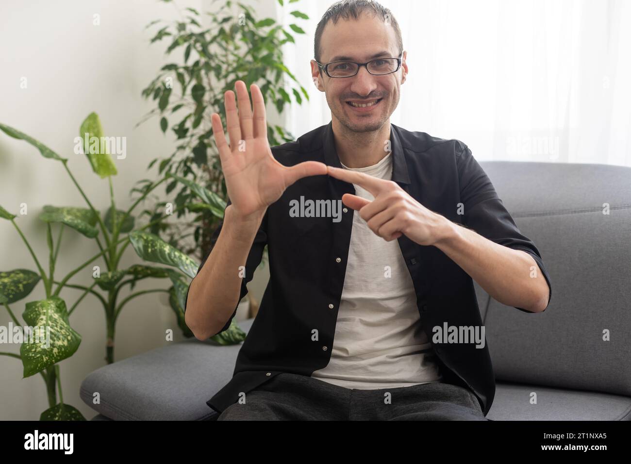 Adult Learning Sign Language For Deaf Disabled Stock Photo - Alamy