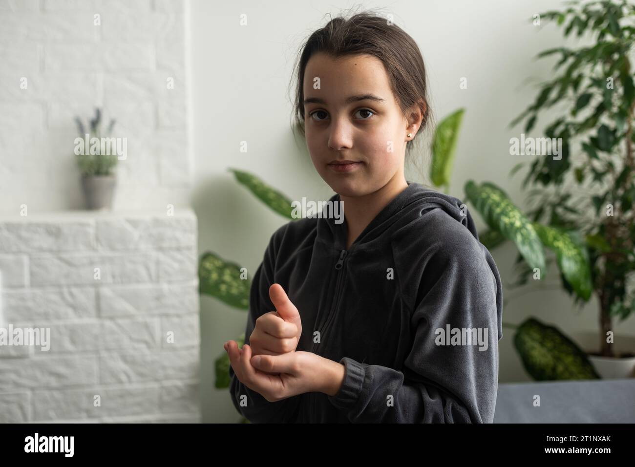 A smiley teenage girl hand sign Stock Photo - Alamy