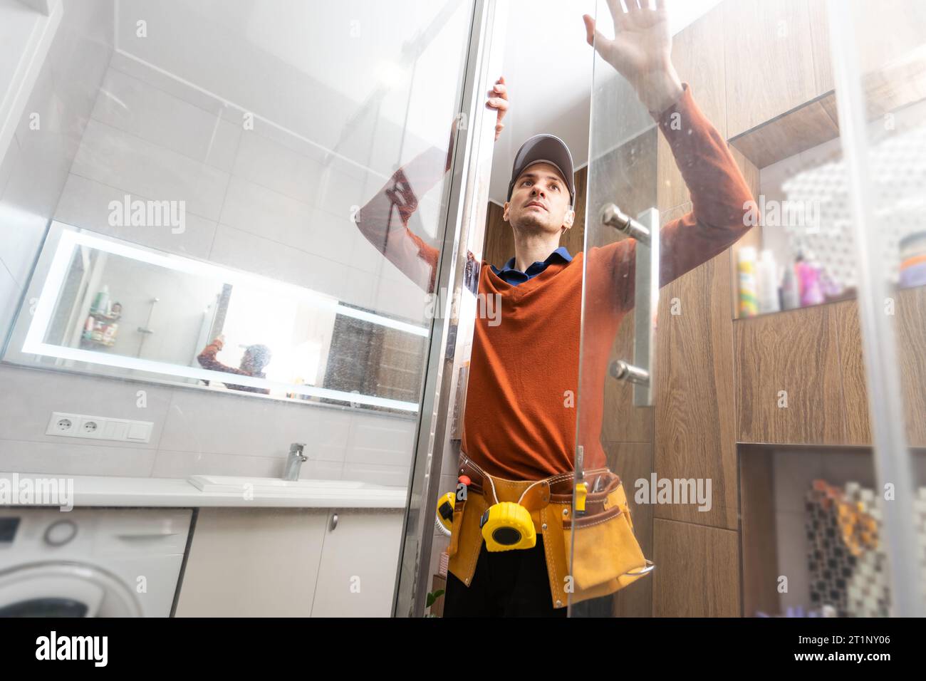 Professional handyman working in shower booth indoors Stock Photo - Alamy