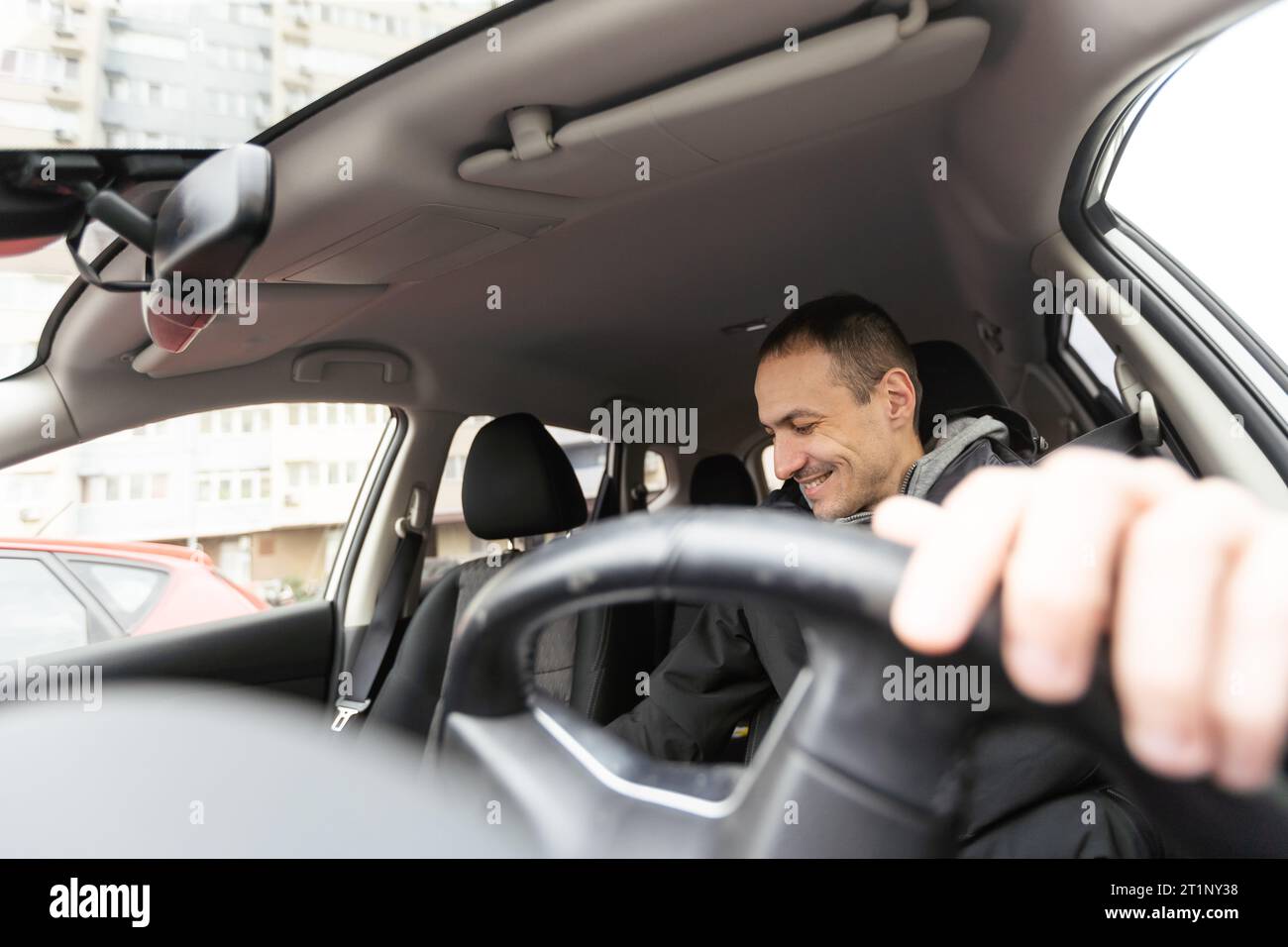 My baby. Shot of a happy man sitting in his car touching the dashboard ...