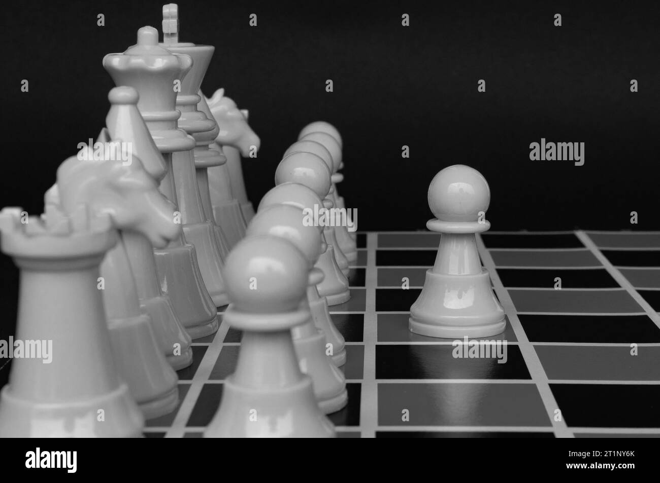 Selective view of chess pawn moving toward for battle with black and ...