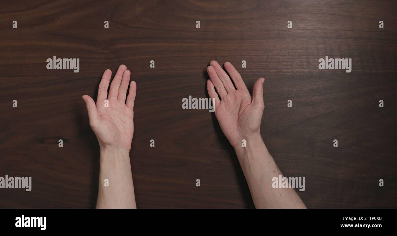 Top view man hands offer gesture black walnut table with copy space ...