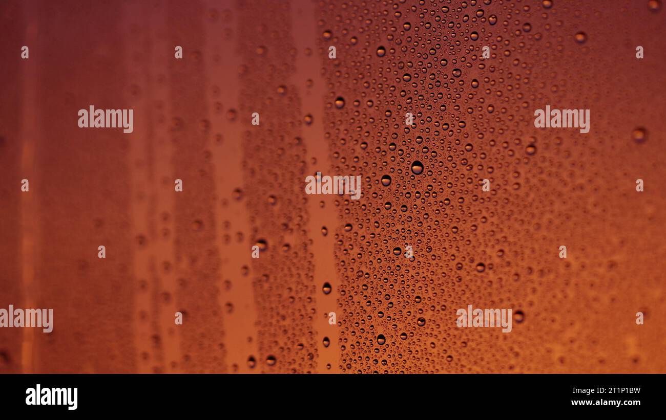 Water drops on window glass with sunset light, wide photo Stock Photo ...