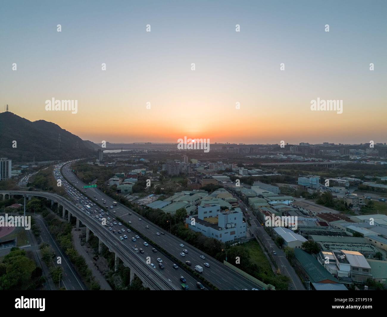 Aerial view of Sanxia District with cars on highway during sunset in New Taipei City, Taiwan ...