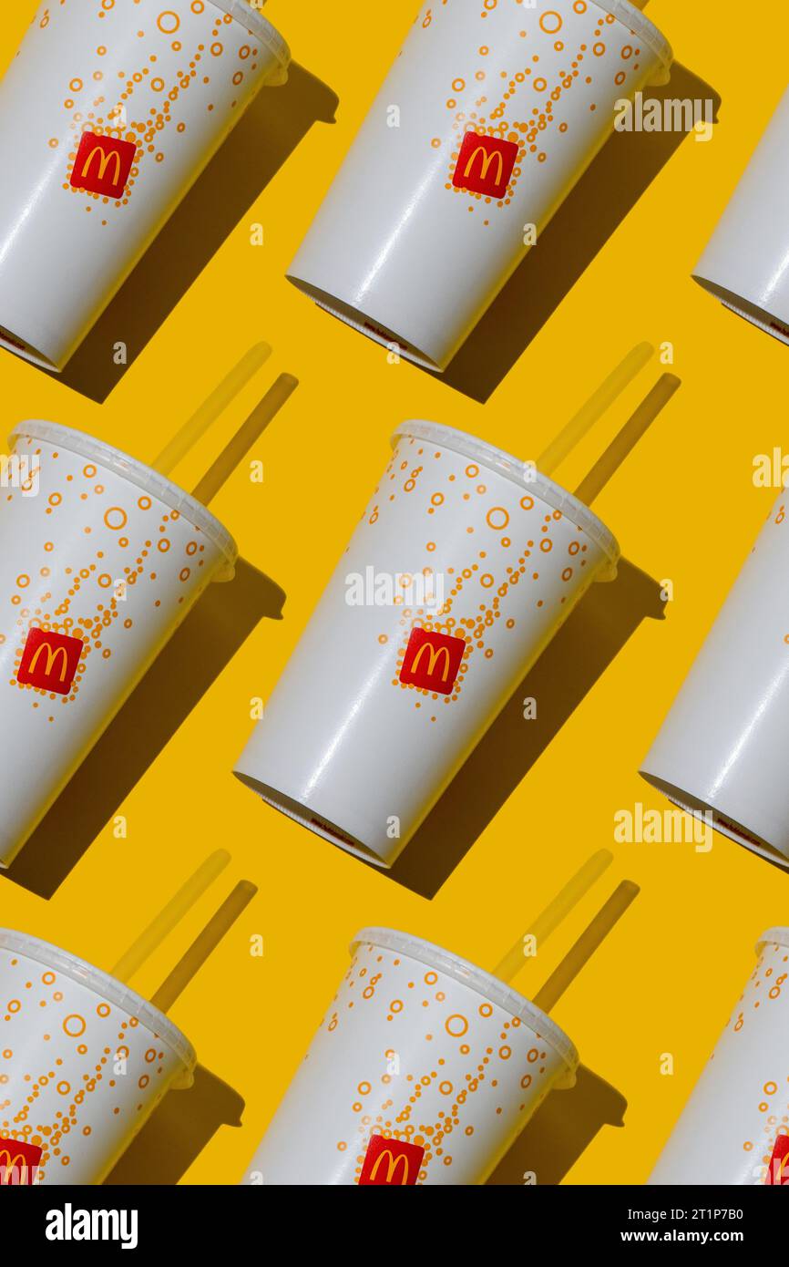 Yellow glass of McDonald's. Paper cup with lid. Takeaway drink ...