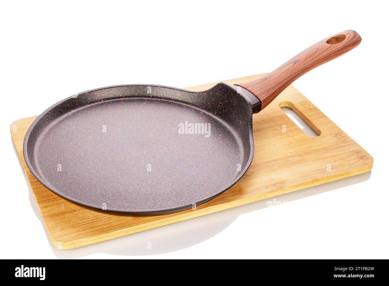 One metal pancake pan on a bamboo kitchen board, macro, isolated on ...