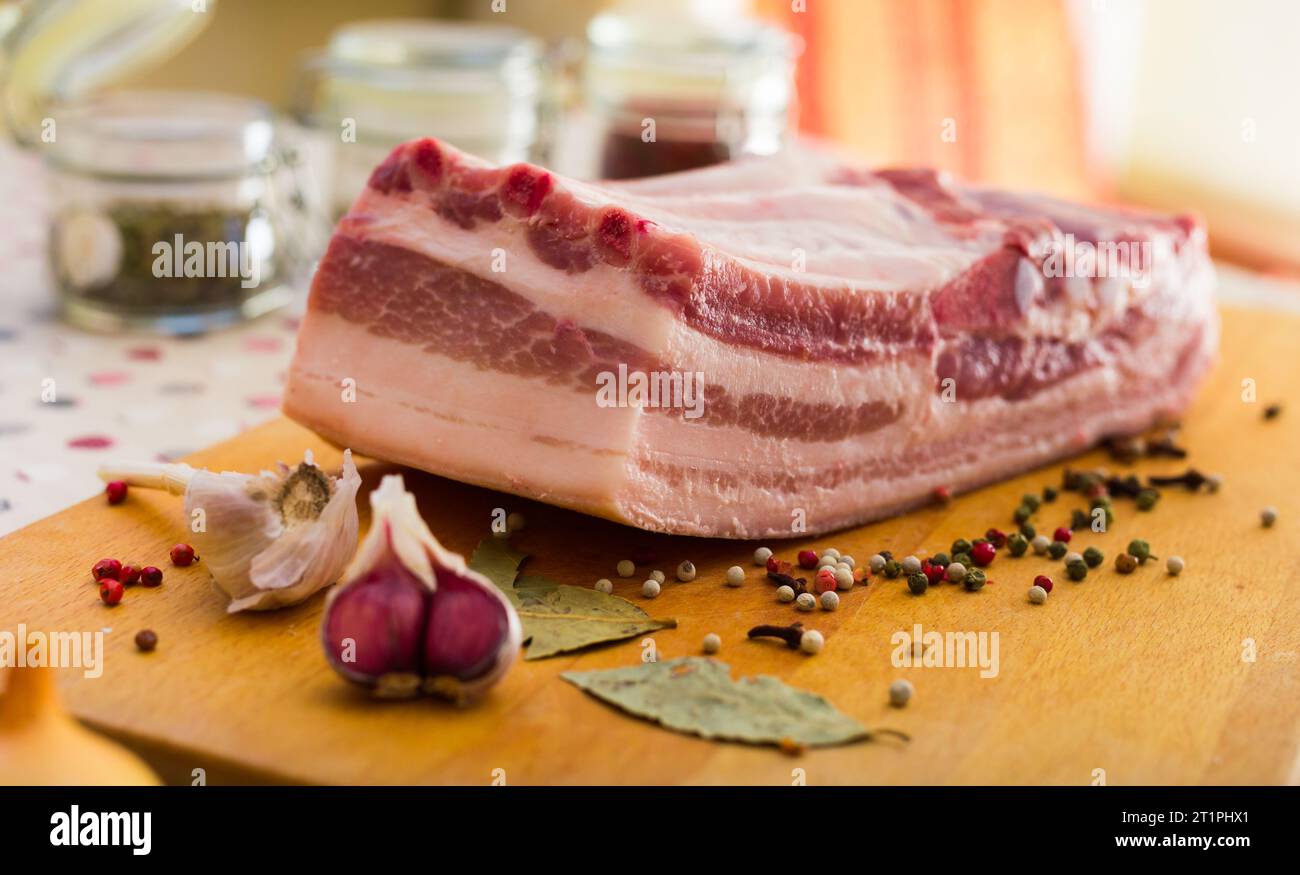 Cooking traditional homemade lard with spices. pork belly with layer on ...