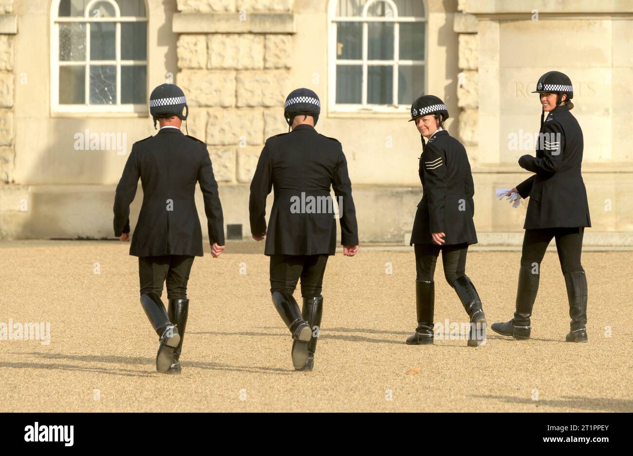 London, UK. Mounted police without their horses, walking across Horse ...