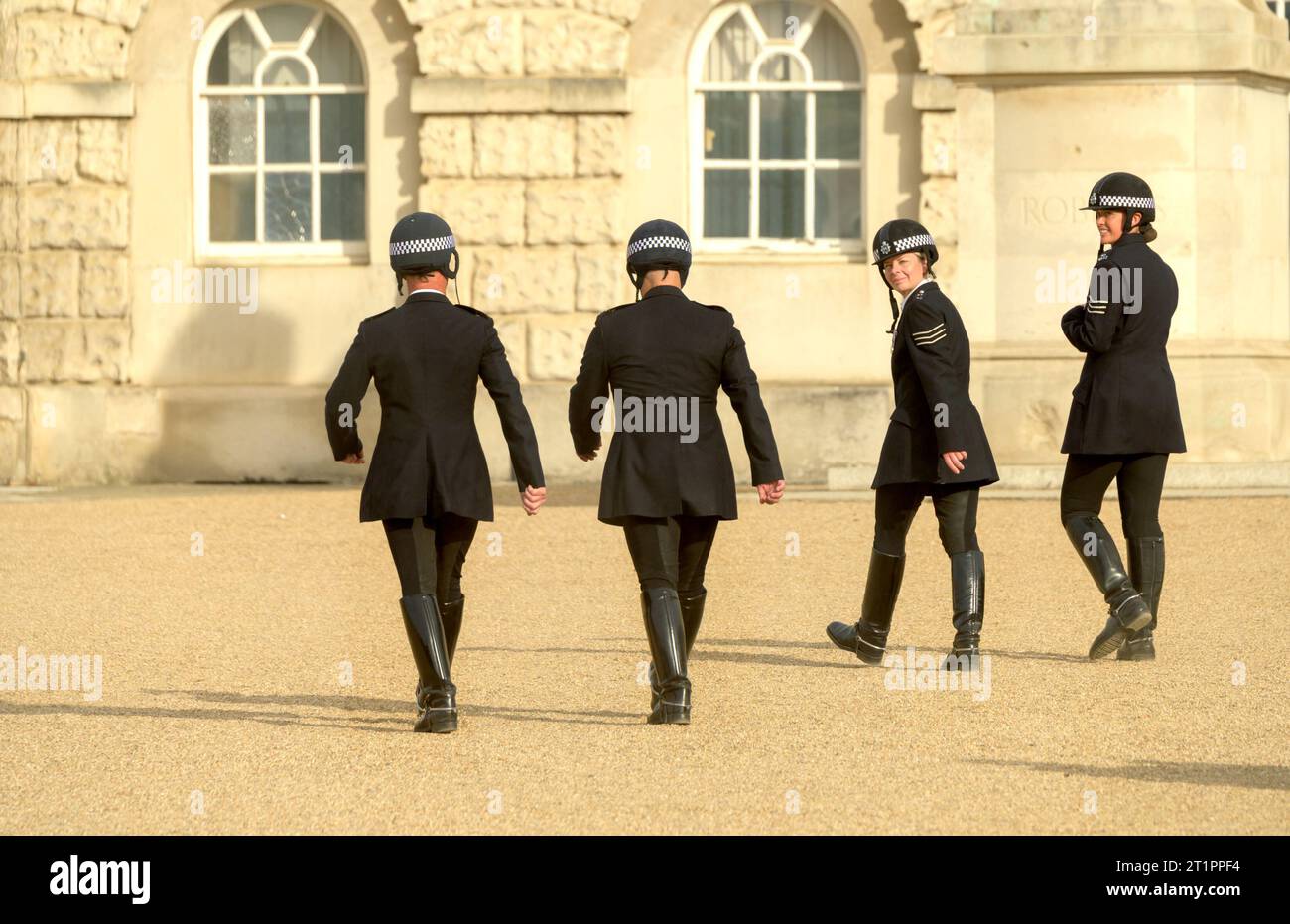 London, UK. Mounted police without their horses, walking across Horse ...