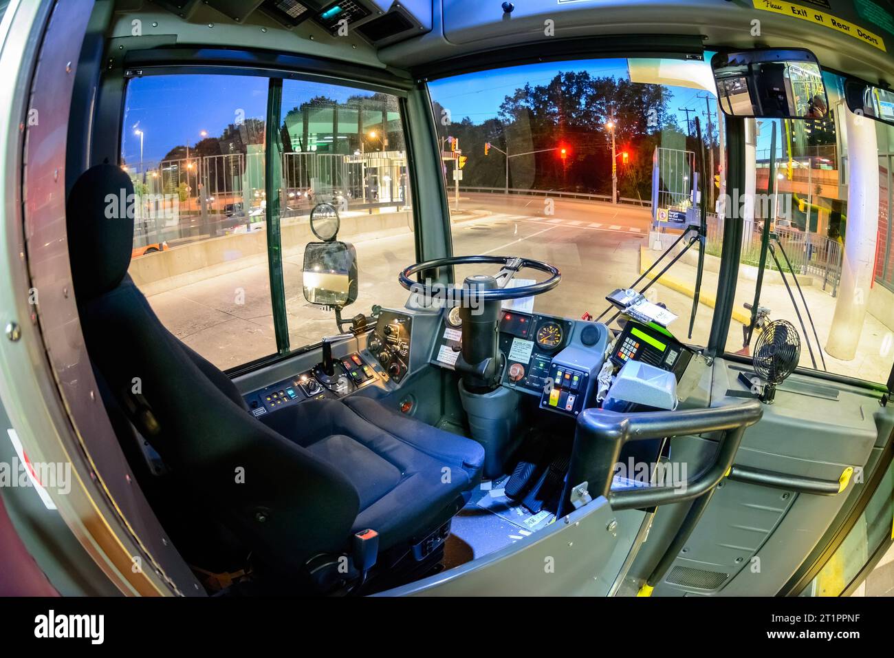 Wide-angle view of a driver's cabin in a TTC bus. Nobody is in the ...