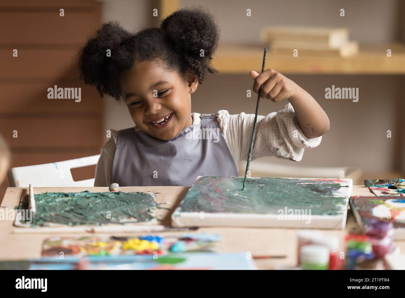 Inspired cute little African girl drawing pictures on canvas Stock ...