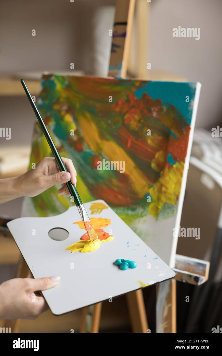 Female painter create picture, mixing colors, working in workshop Stock ...