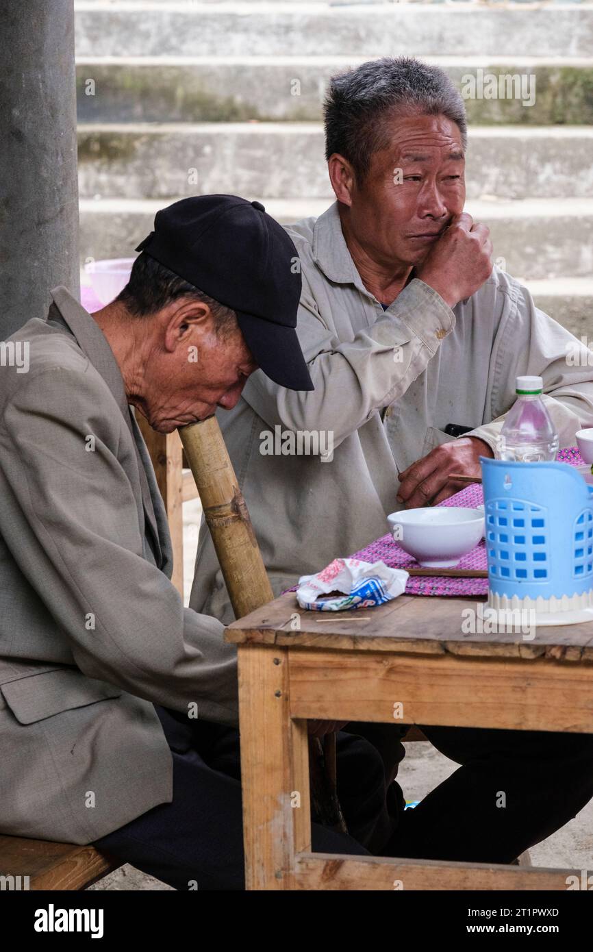 Can Cau Market Scene, Vietnam. Hmong Man Smoking a Bamboo Pipe while at ...