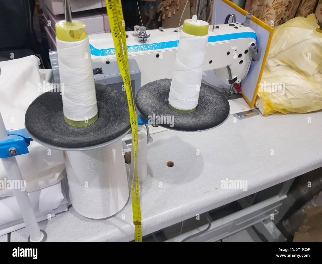 Garment factory. Atelier with sewing machine and fabric. Tailoring industry, sewing workshop ...