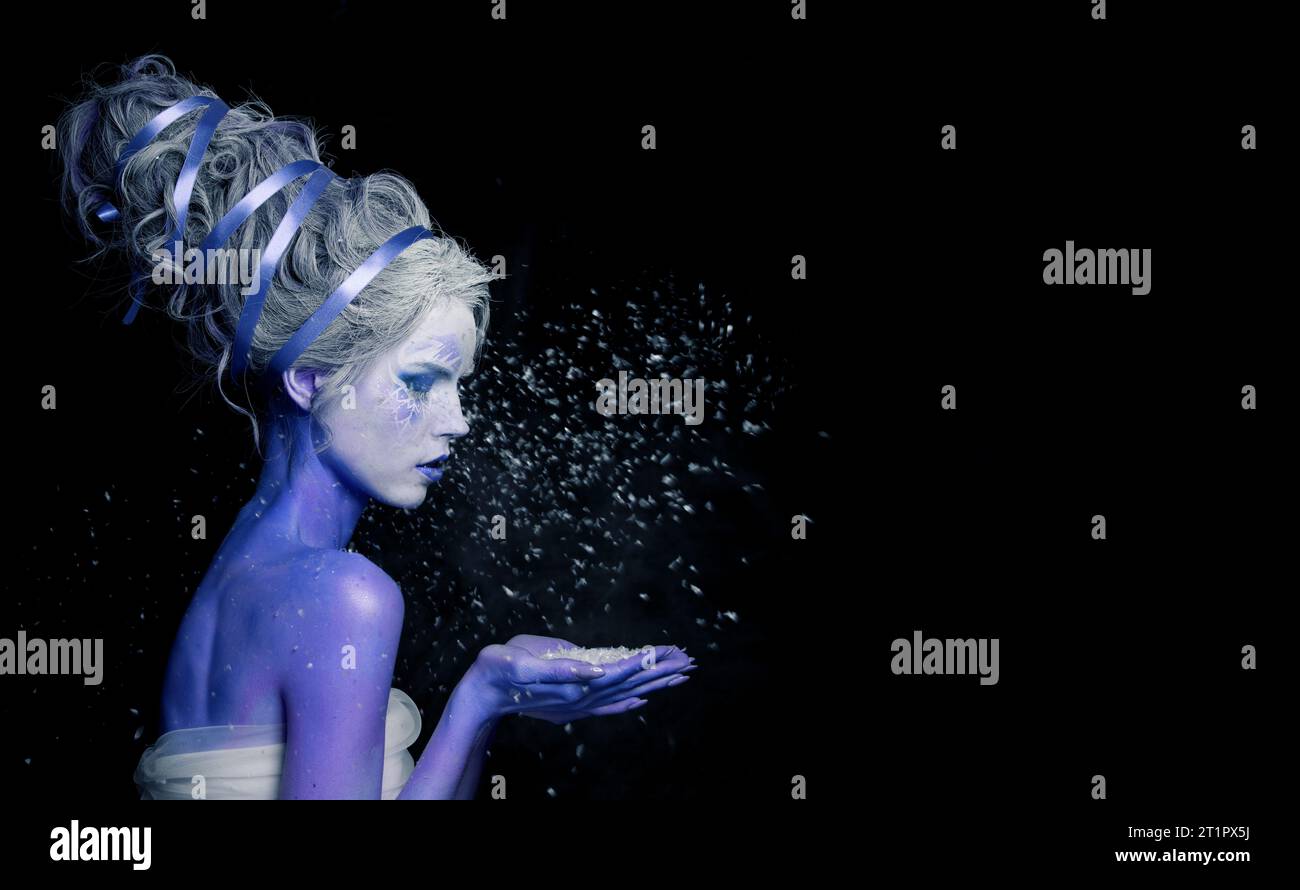 Snow Queen or Winter Witch woman blowing snowflake. Beautiful female ...