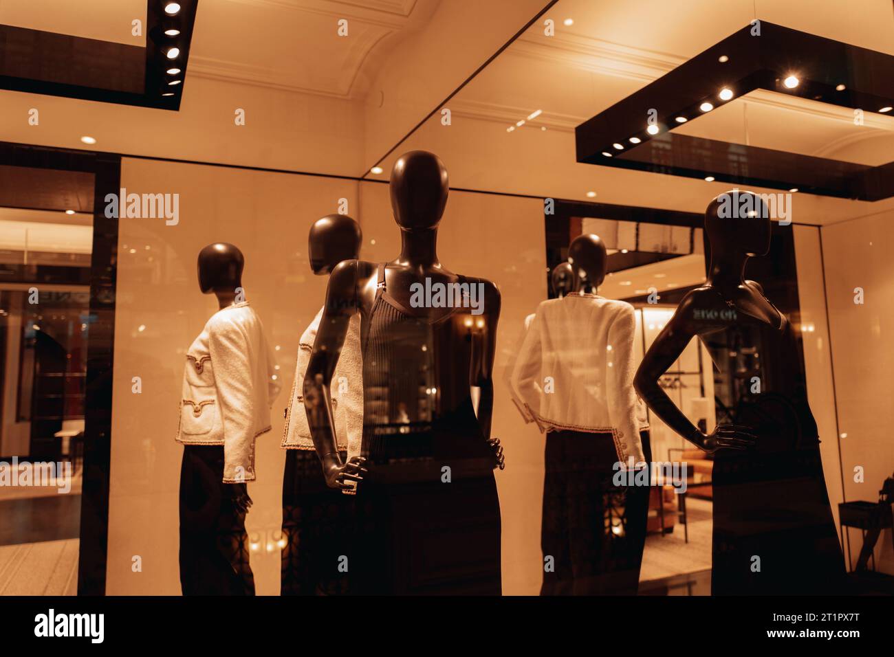Black stylish mannequins in a shop window dressed in a fashionable ...