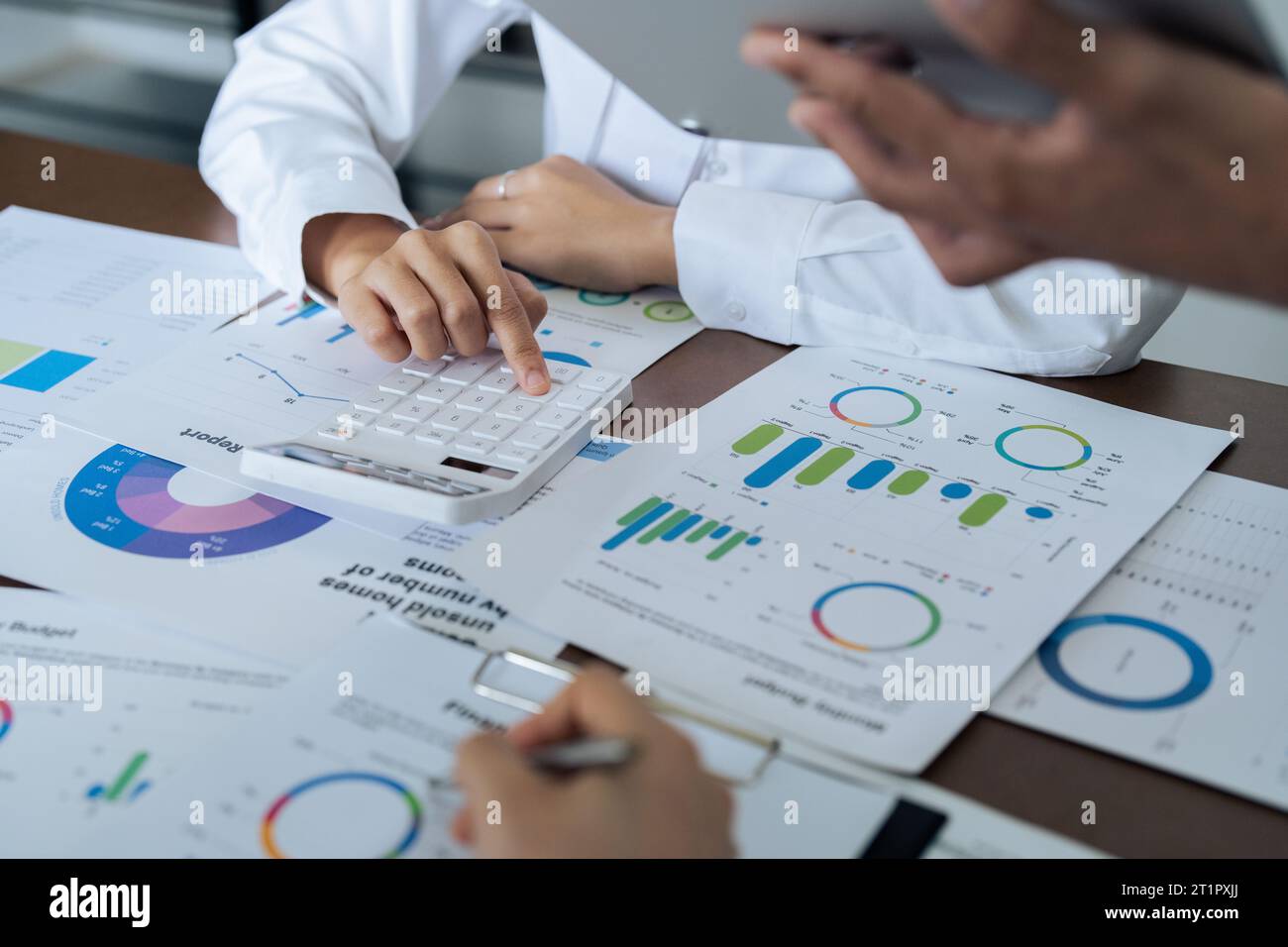 Businesswoman using a calculator to calculate numbers on a company's ...