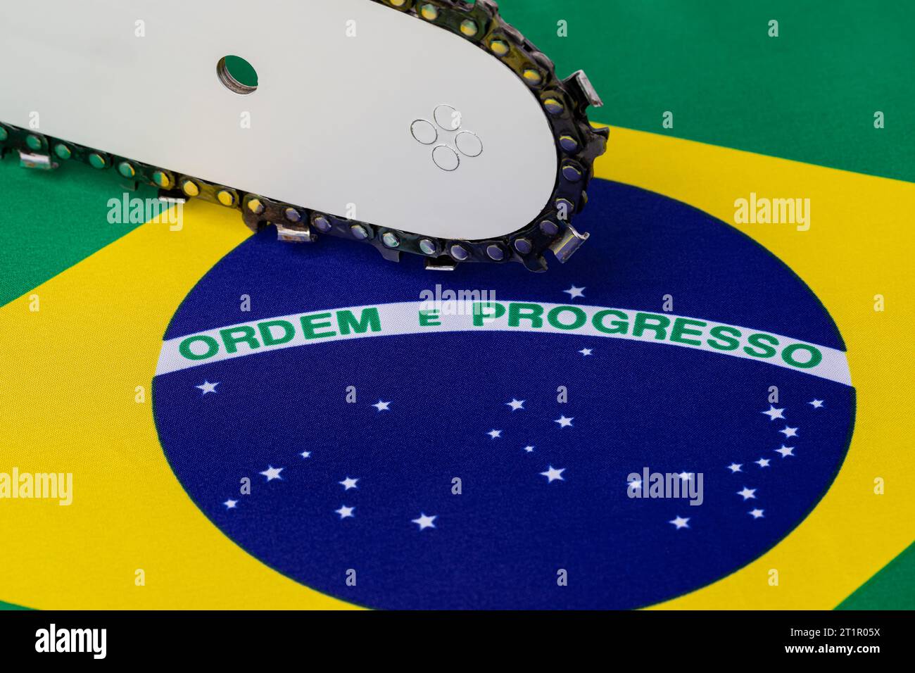 Brazil flag and chainsaw. Deforestation, rainforest destruction and ... Brazil flag and chainsaw. Deforestation, rainforest destruction and ...