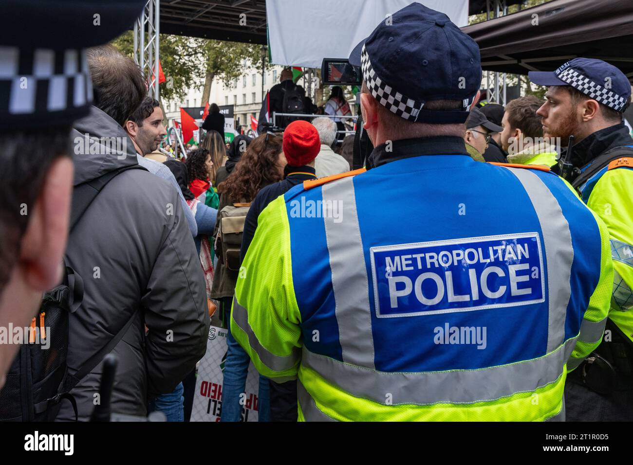 London, UK. 14th October, 2023. A Metropolitan Police officer uses a ...