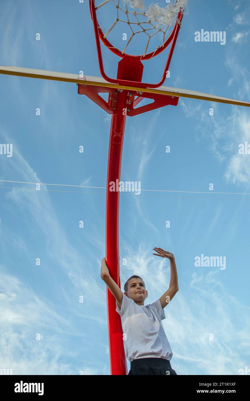 Basketball Aspirations Soar: Brave Boy Grasps Hope Above the Court ...