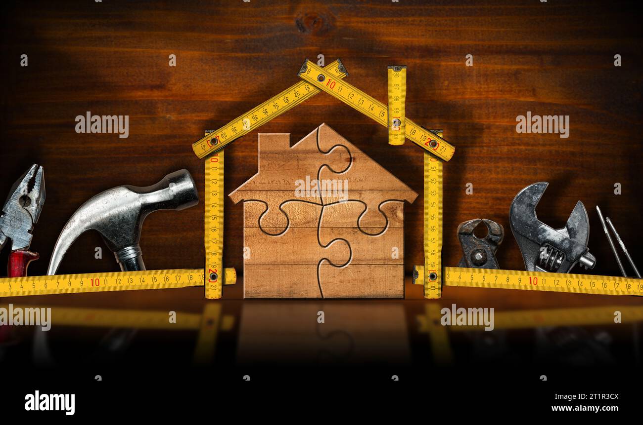 Home improvement concept. Wooden house made of puzzle pieces and a ...