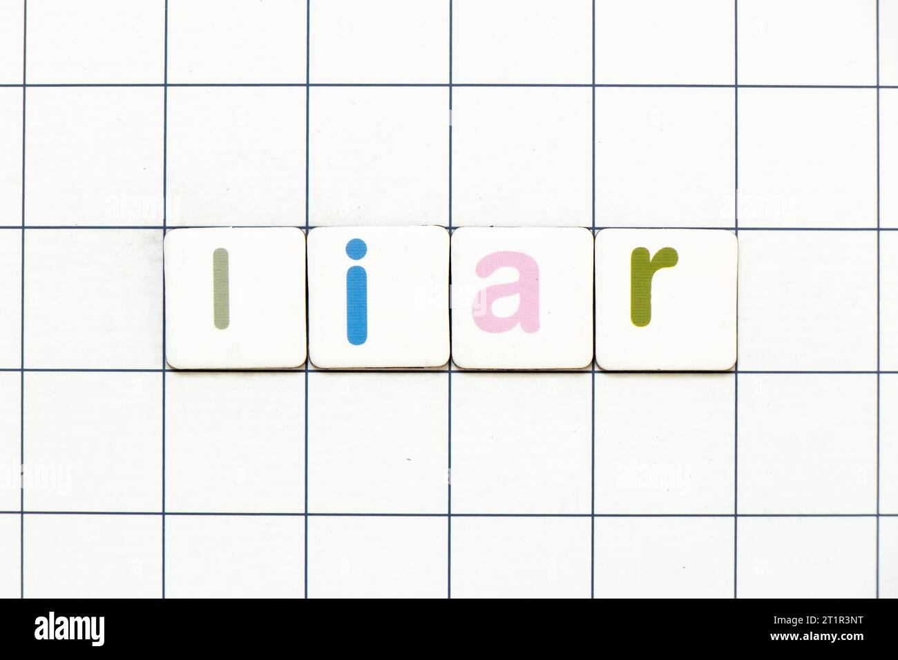 Colorful tile letter in word liar on white grid background Stock Photo ...