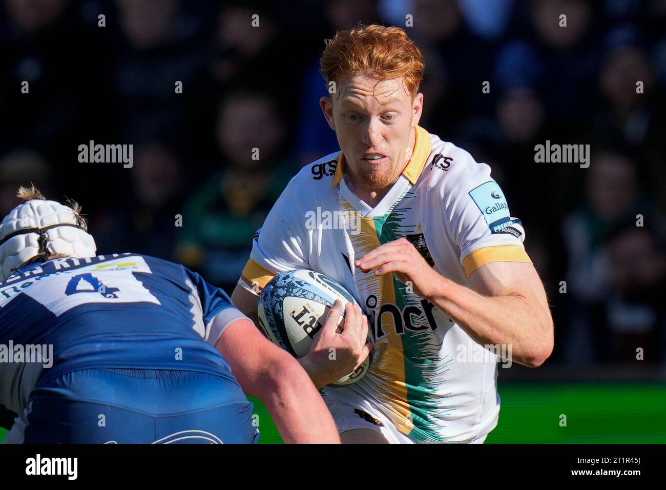 George Hendy #15 of Northampton Saints runs at Ernst Van Rhyn #4 of ...