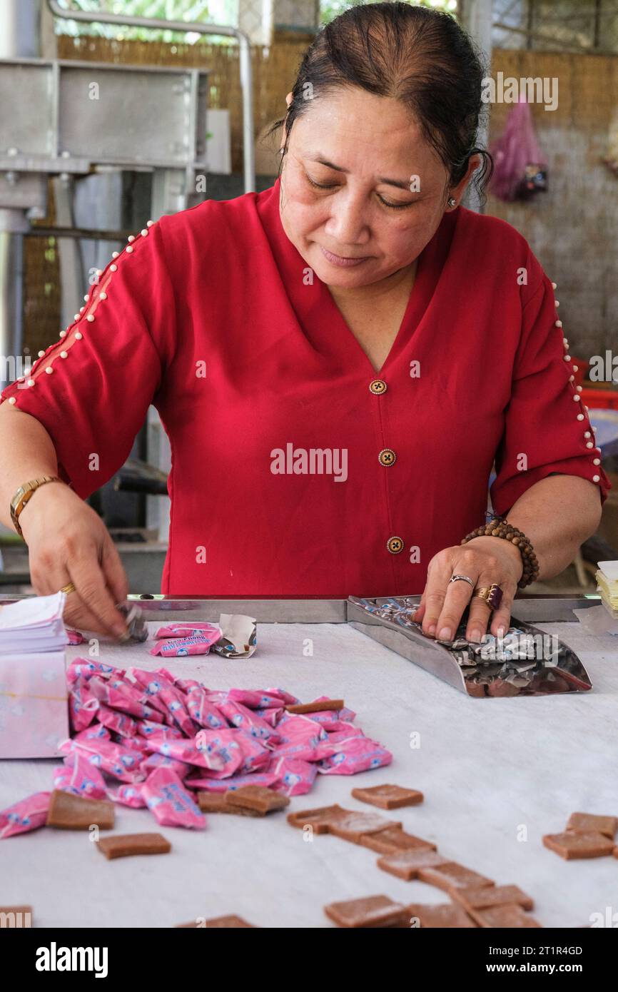 Mekong River, Vietnam. Woman Wrapping Candy in Coconut Candy Factory ...