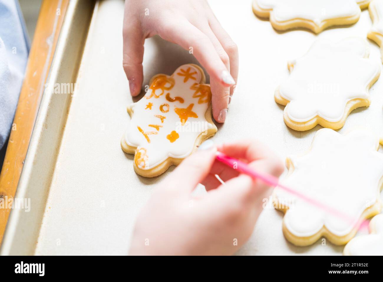Little Girl Spells 'Sorry' on Iced Sugar Cookies Stock Photo - Alamy