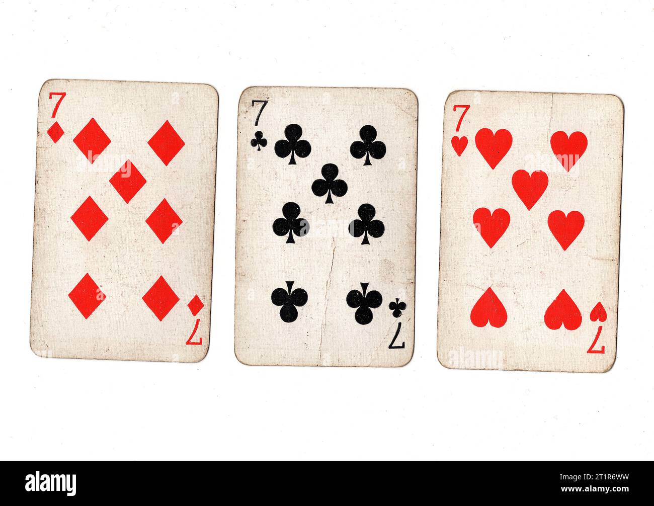 Vintage playing cards featuring three sevens on a white background ...
