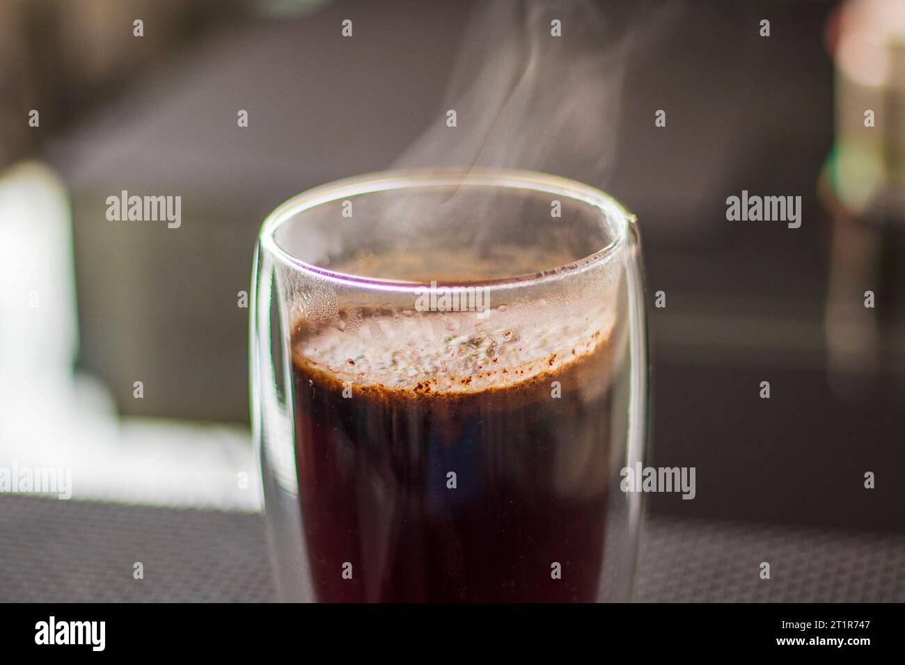 Shot of the hot water poured into the transparent cup to brew the ...