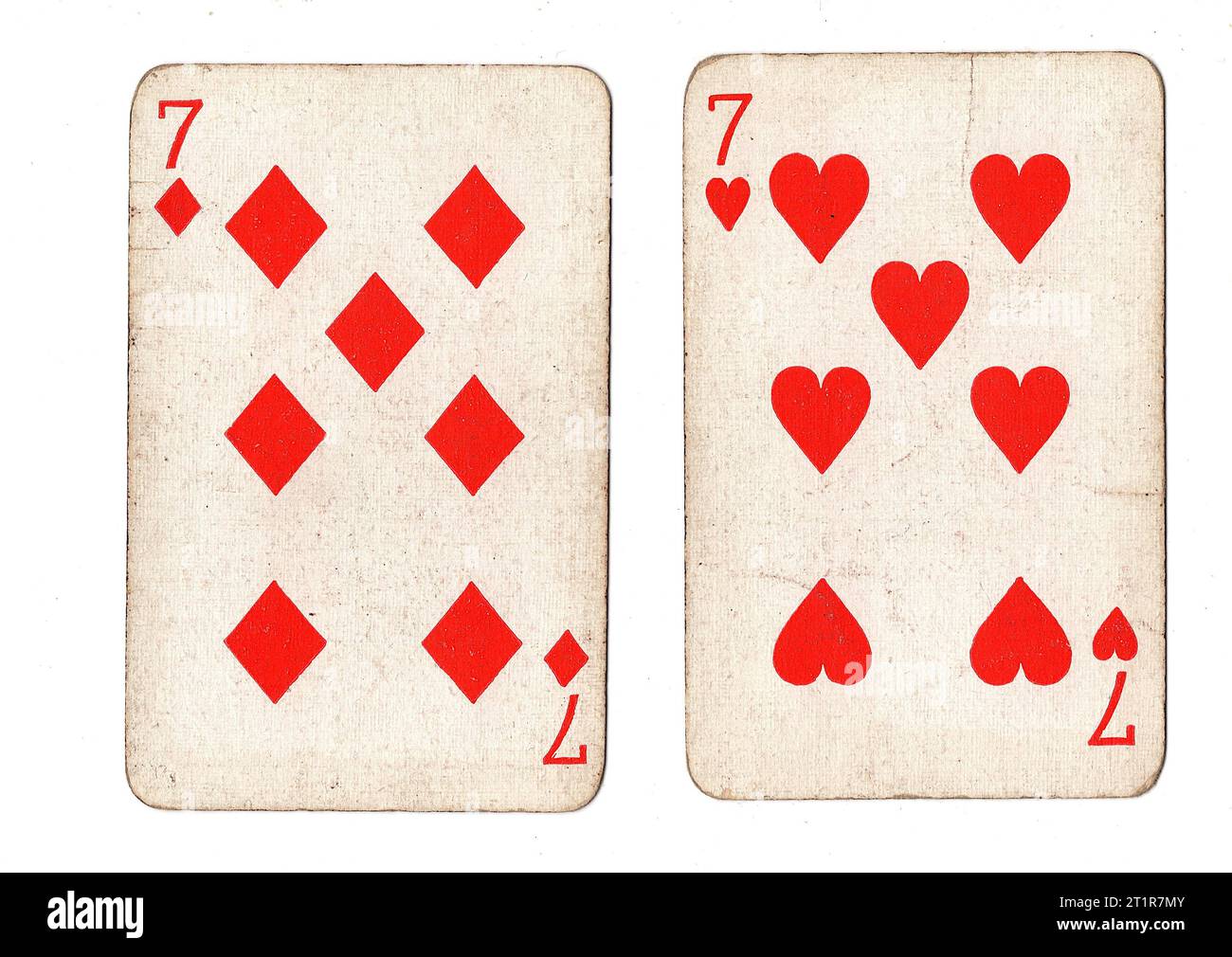 Vintage playing cards featuring a pair of red sevens on a white ...