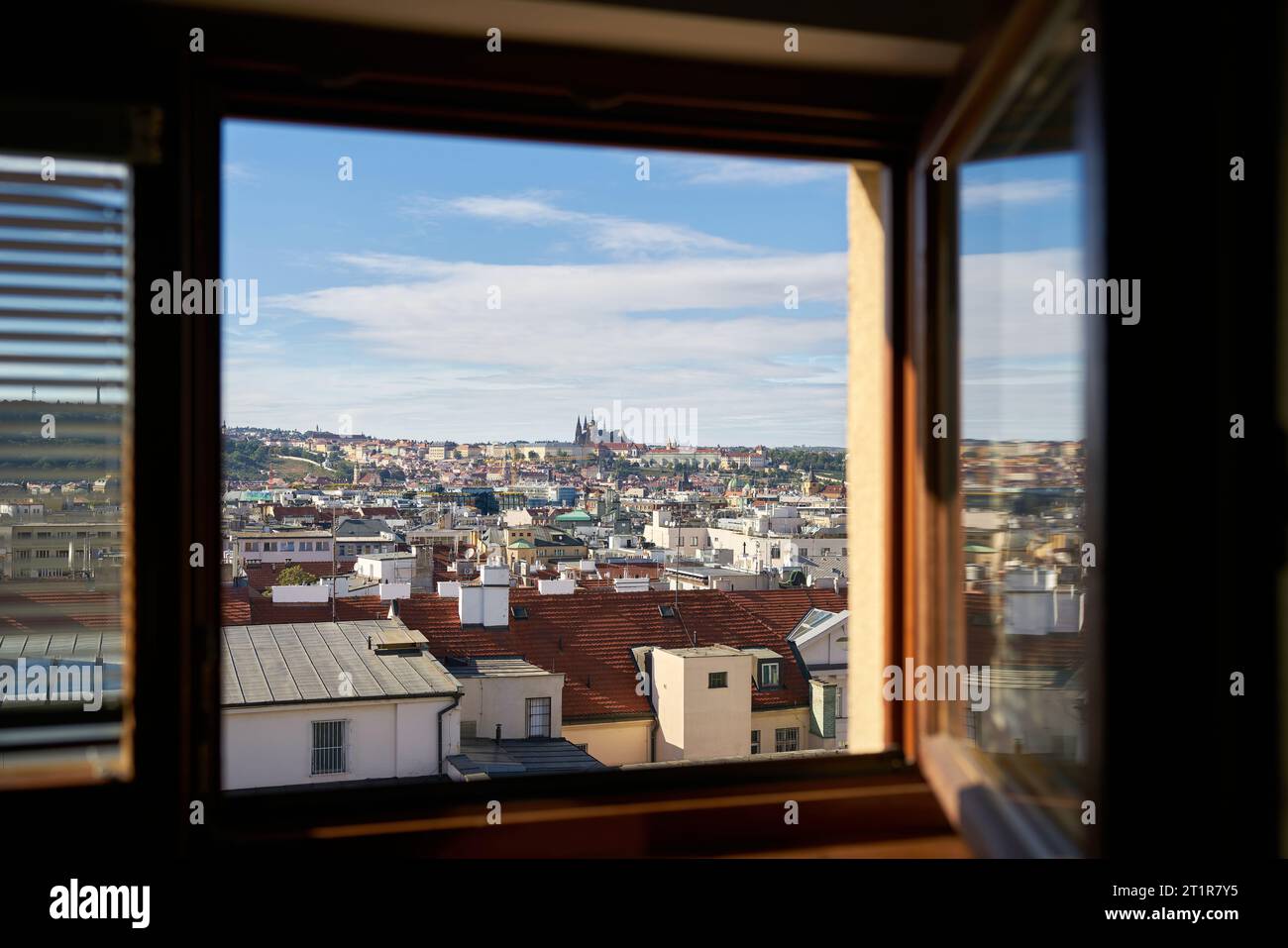 View through the open window of a hotel room over the old town of ...