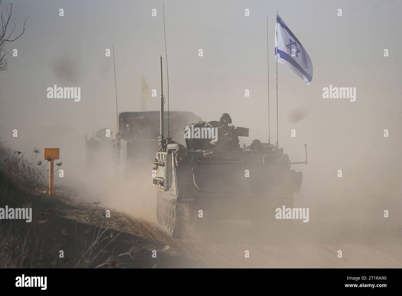 A convoy of Israeli armoured personnel carriers (APC) head towards the ...