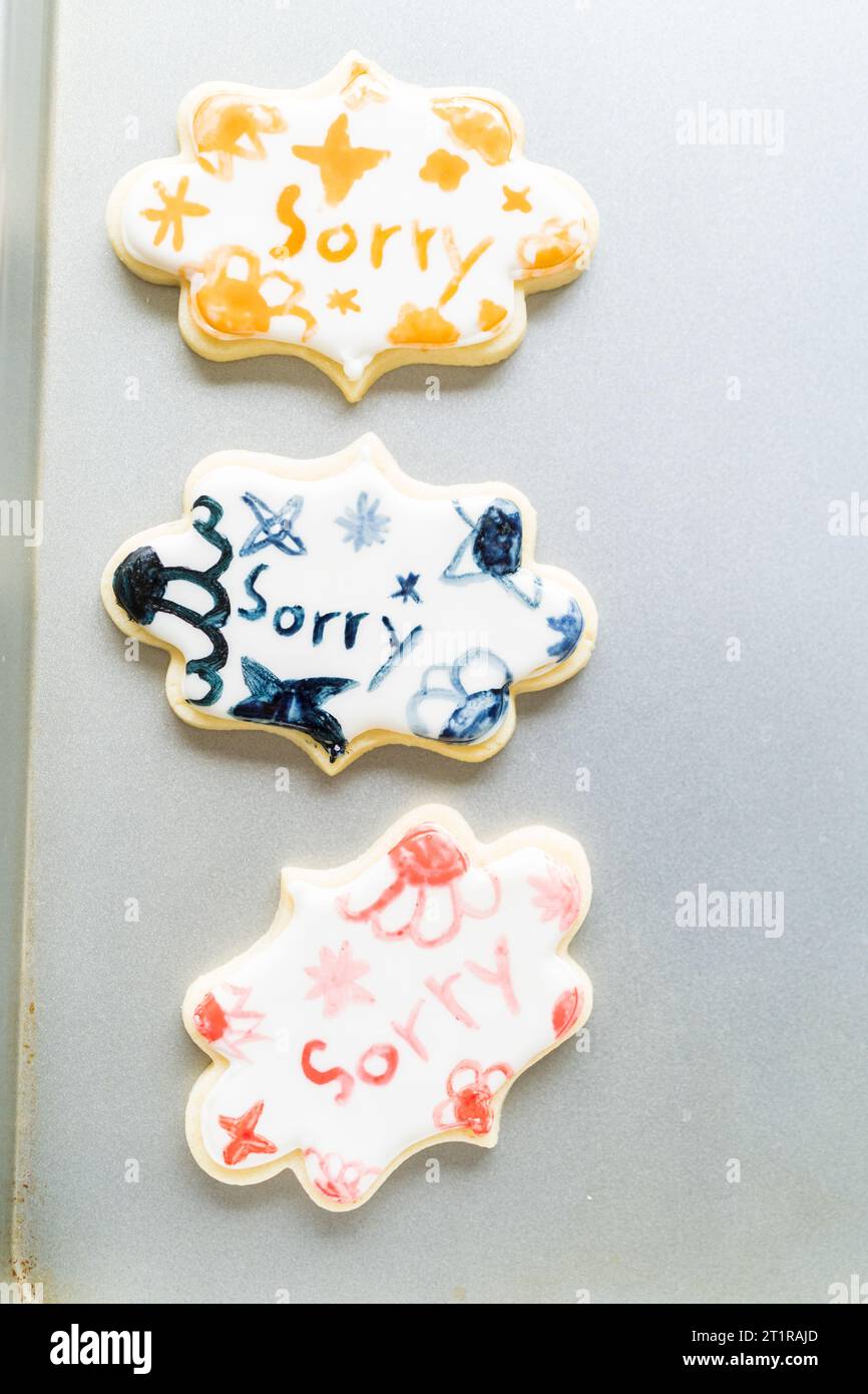 Little Girl Spells 'Sorry' on Iced Sugar Cookies Stock Photo - Alamy