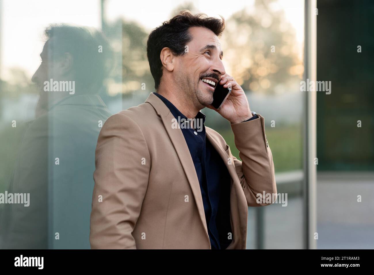 Professional Man Talking on Phone Amidst City Vibes Stock Photo - Alamy