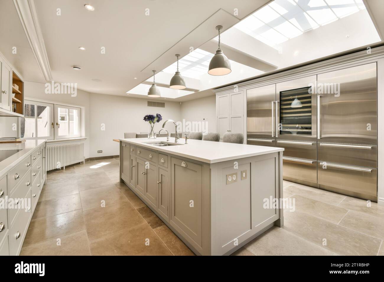 a kitchen with an island and skylight over the sink area in this modern ...