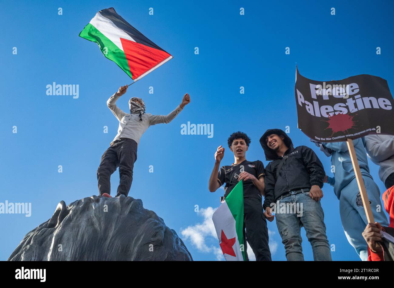 London, UK. 14 Oct 2023: Pro-Palestinian protesters stand on the statue ...
